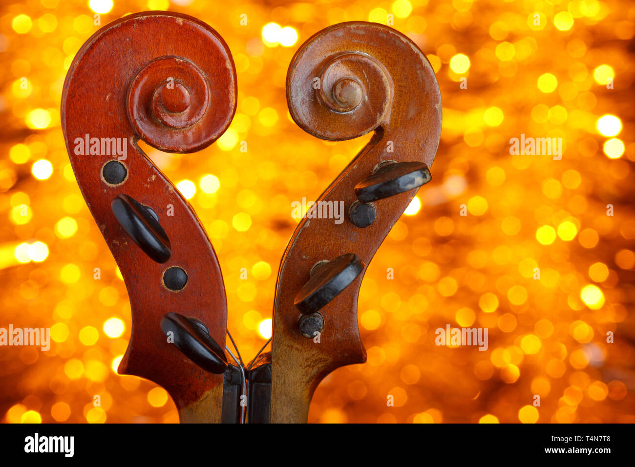 Two vintage violin scrolls make heart shape with copy-space Stock Photo ...