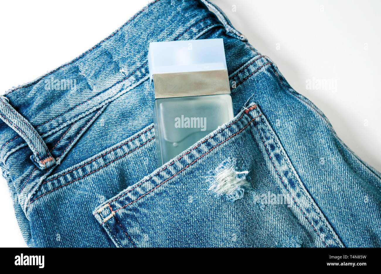 Bottle of perfume on the jeans Stock Photo - Alamy