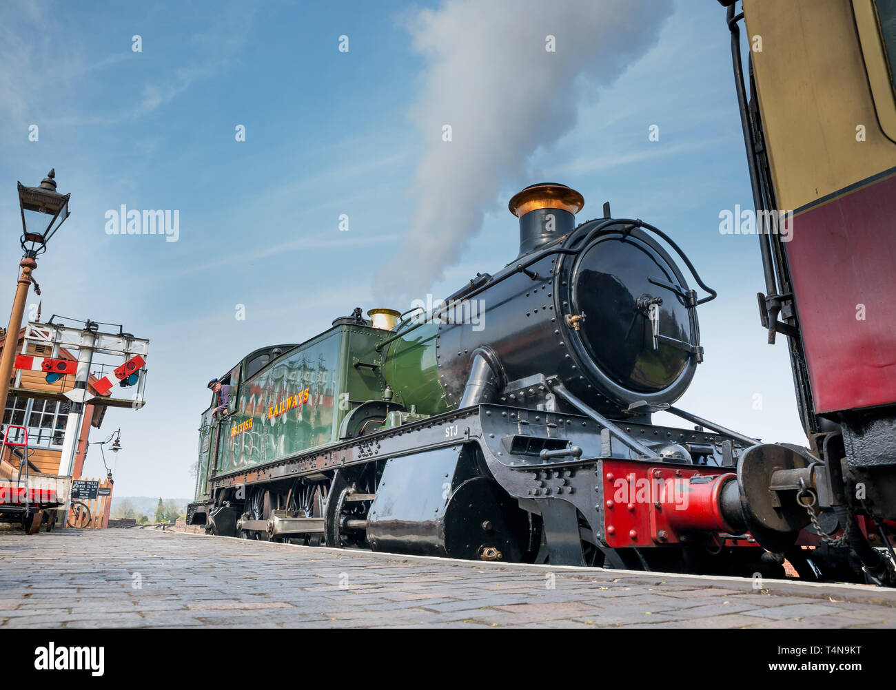 Low angle close up of vintage UK steam locomotive in morning spring ...