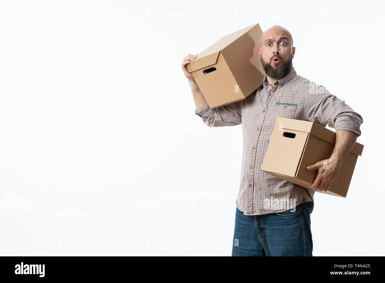 Portrait of a handsome young man holding card boxes, isolated on white ...