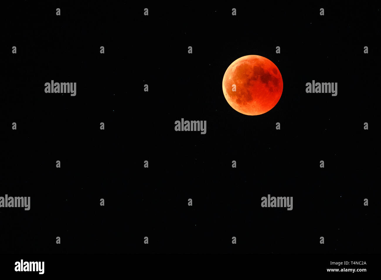 Astronomical background. Closeup of full red moon over dark black sky ...