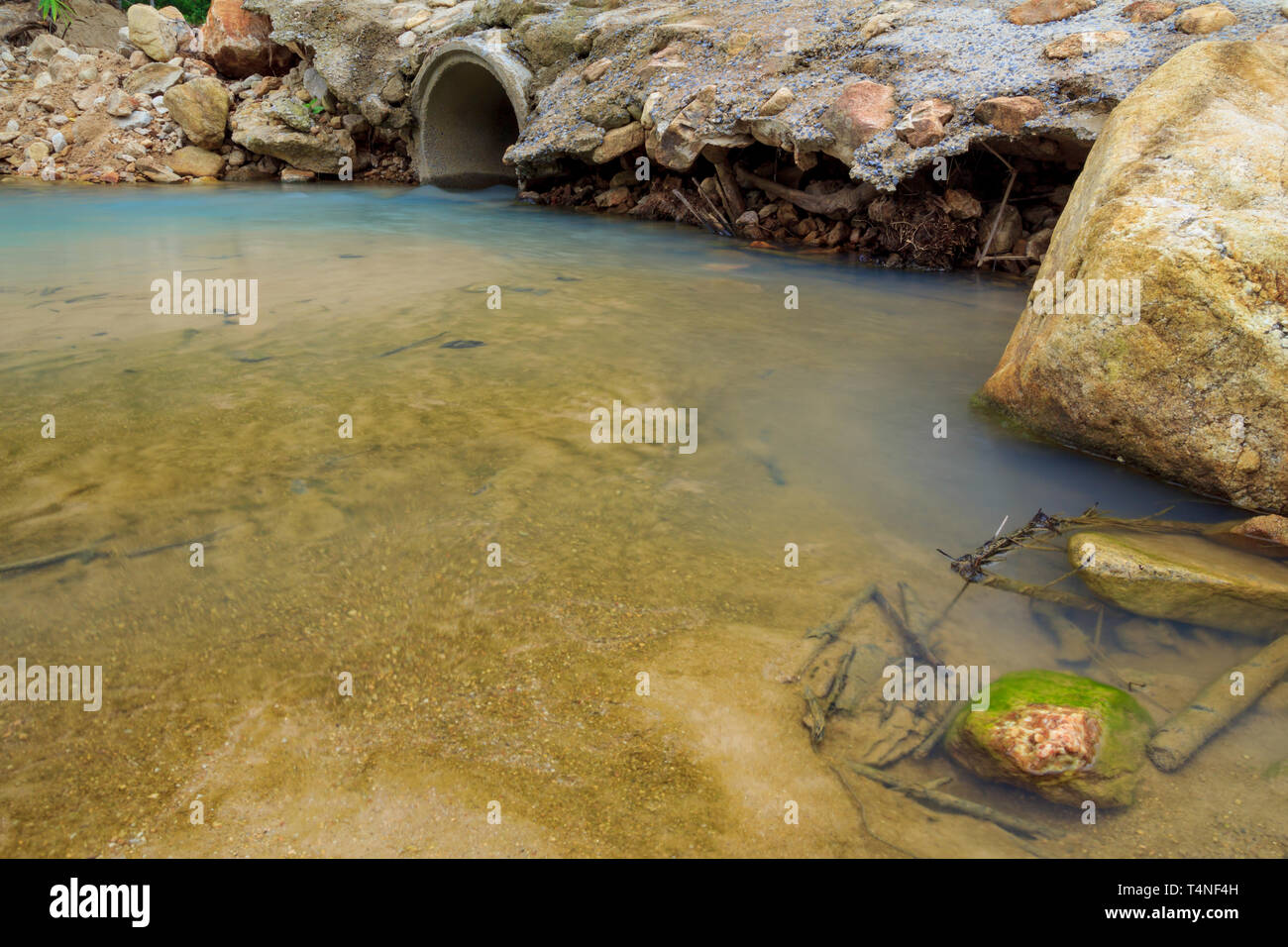 Water sewer pipe with running flow Stock Photo - Alamy