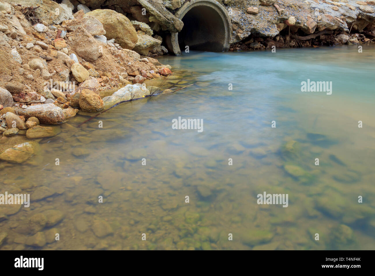 Water sewer pipe with running flow Stock Photo - Alamy