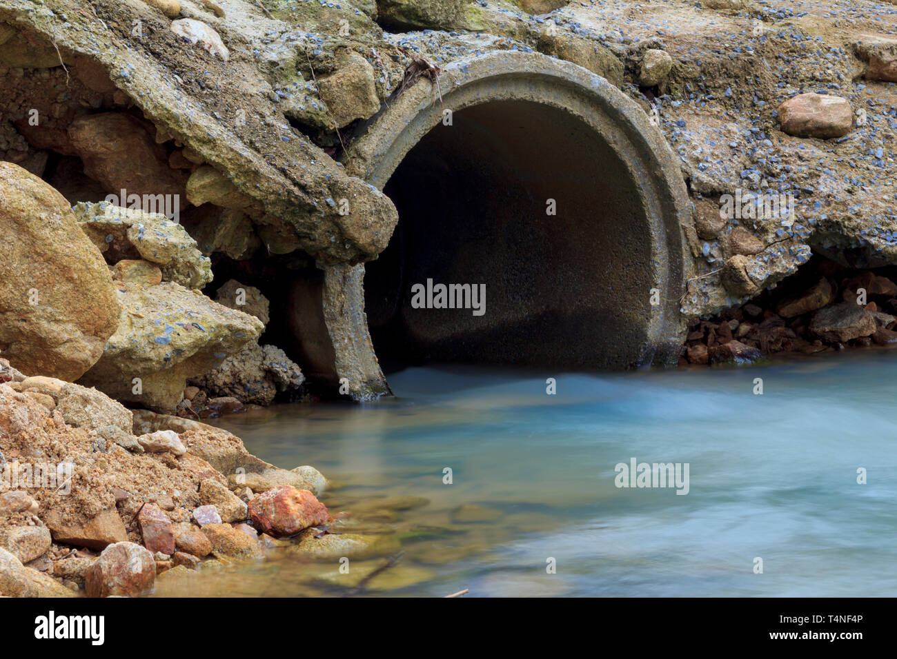 Water sewer pipe with running flow Stock Photo - Alamy
