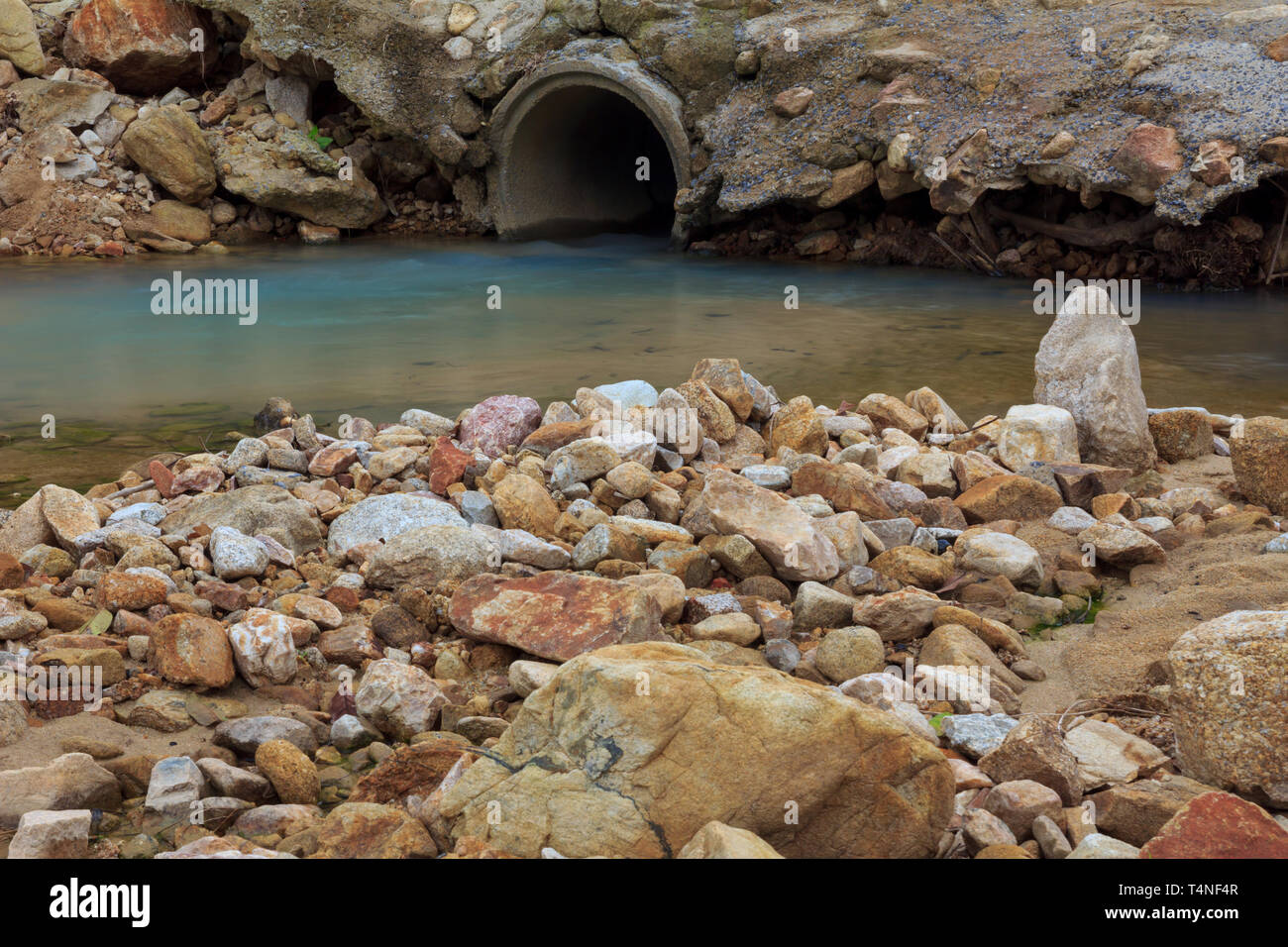 Water sewer pipe with running flow Stock Photo - Alamy