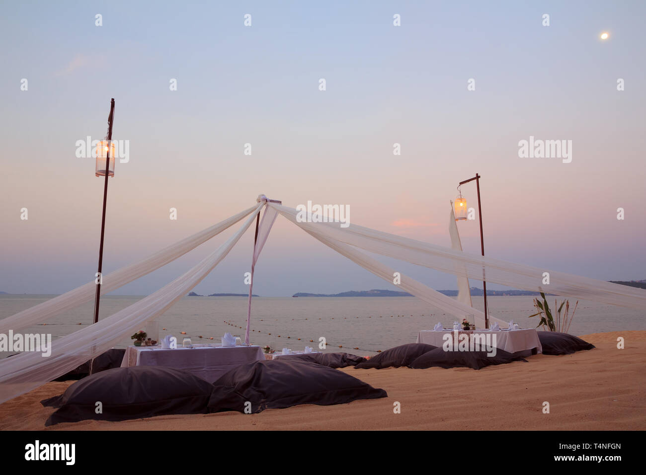 Romantic dinner setting on tropical beach at moonlight Stock Photo - Alamy