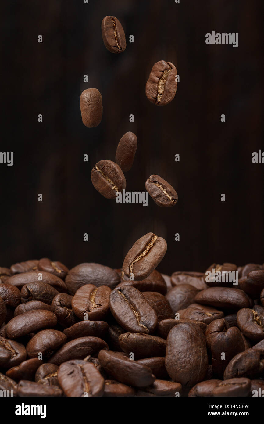 Coffee beans falling down Stock Photo - Alamy