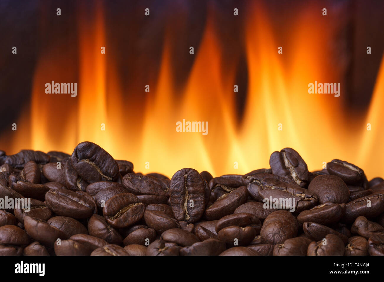 Coffee beans roasting with fire on background Stock Photo - Alamy