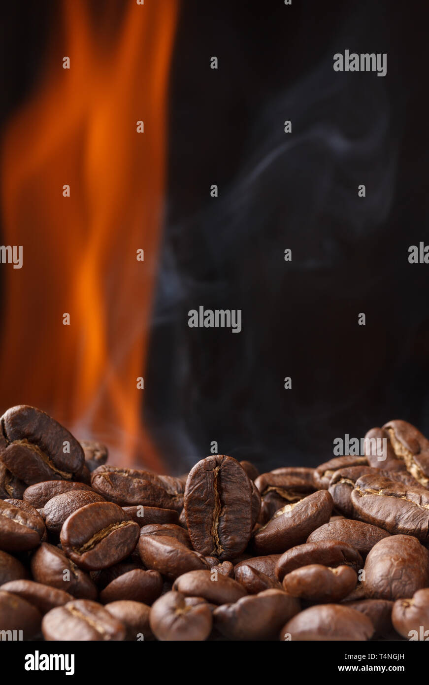 Coffee beans roasting with fire and smoke Stock Photo - Alamy