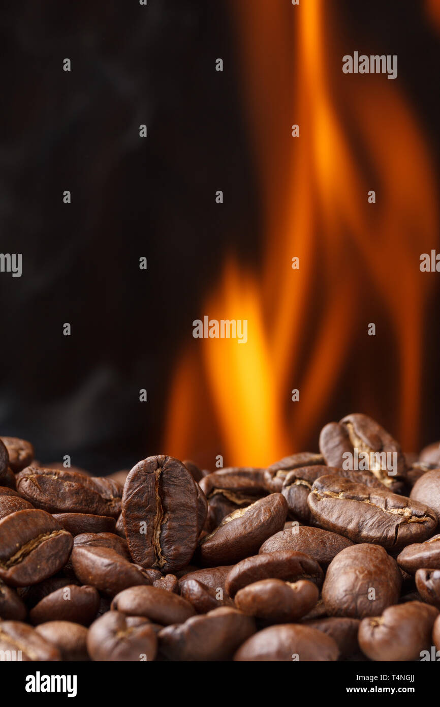 Coffee beans roasting with fire and smoke Stock Photo - Alamy