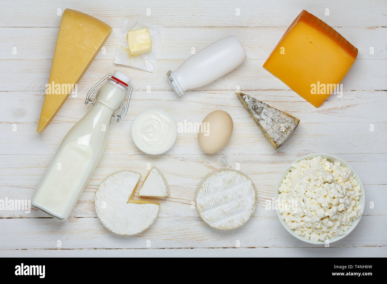 Dairy products assortment on wooden table - milk, cheese, egg, yogurt ...
