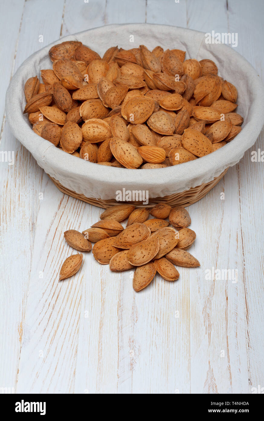 Almonds in shell on wooden table still life Stock Photo - Alamy
