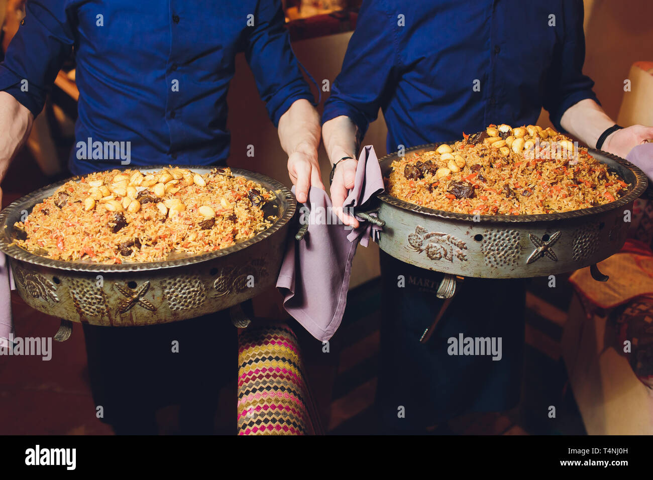 Pilaf in cauldron. A delicious pilaf with pork, carrots and rice with ...