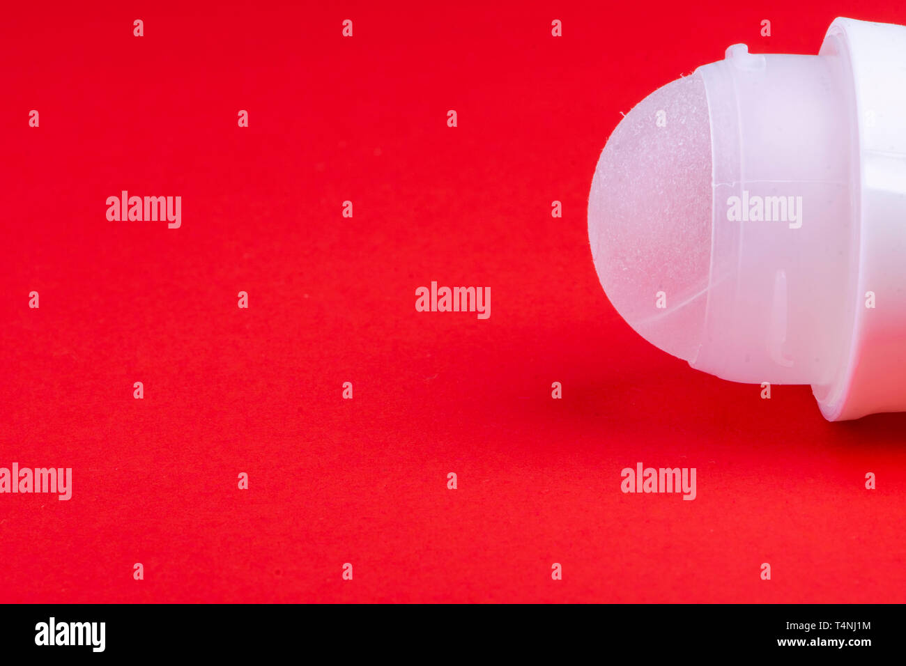 white deodorant stick to roll with cap on red background Stock Photo ...