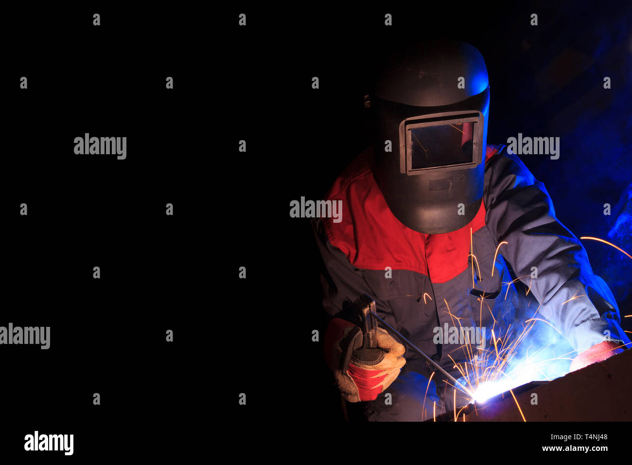 Working welder on black background with copy space Stock Photo - Alamy