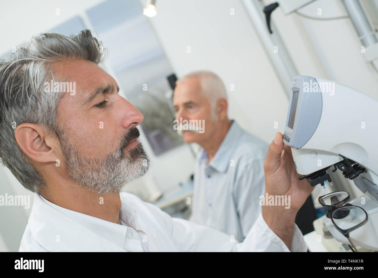 an optometrist doing vision testing Stock Photo - Alamy