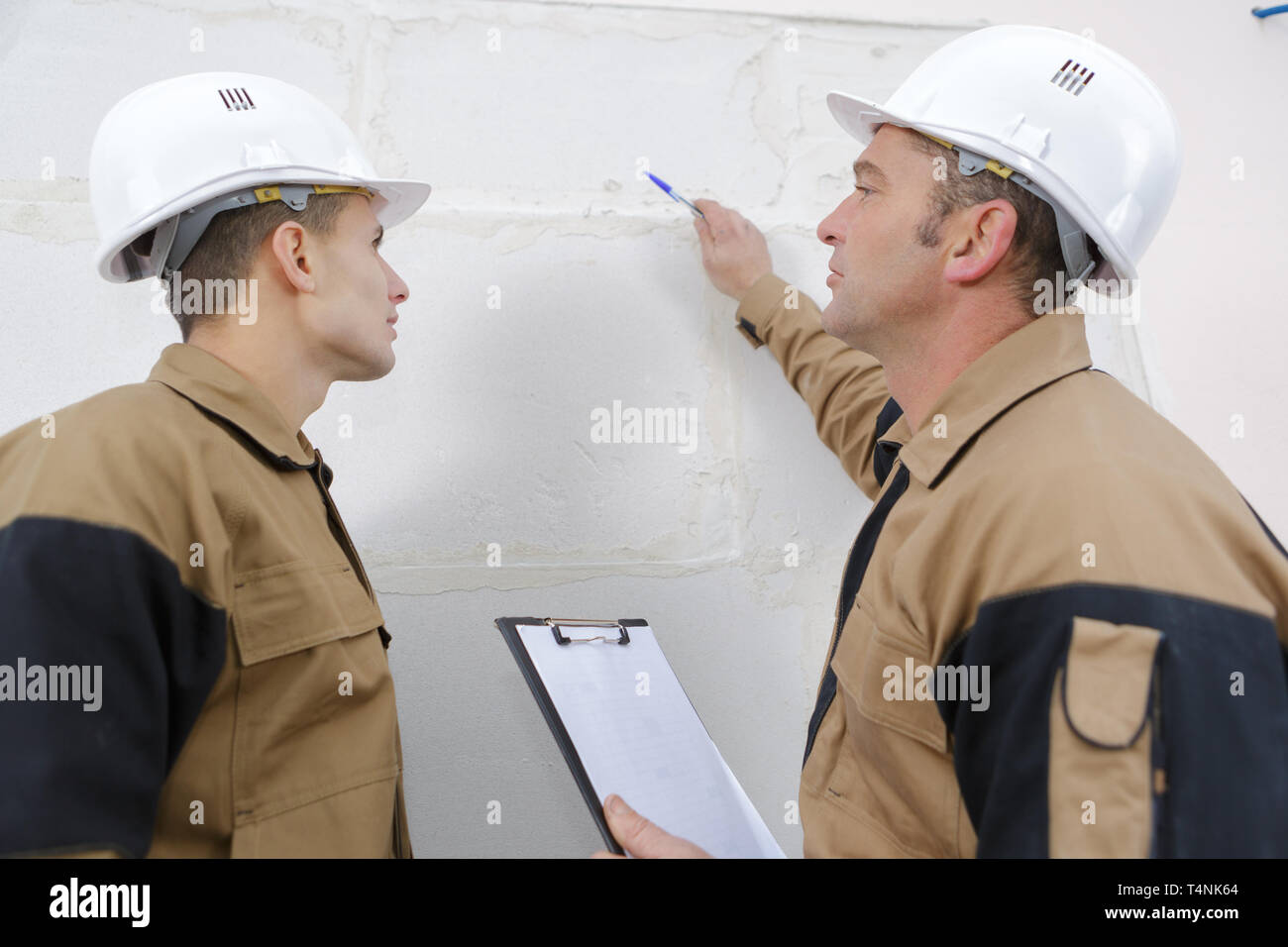 construction workers renovating exterior walls Stock Photo - Alamy