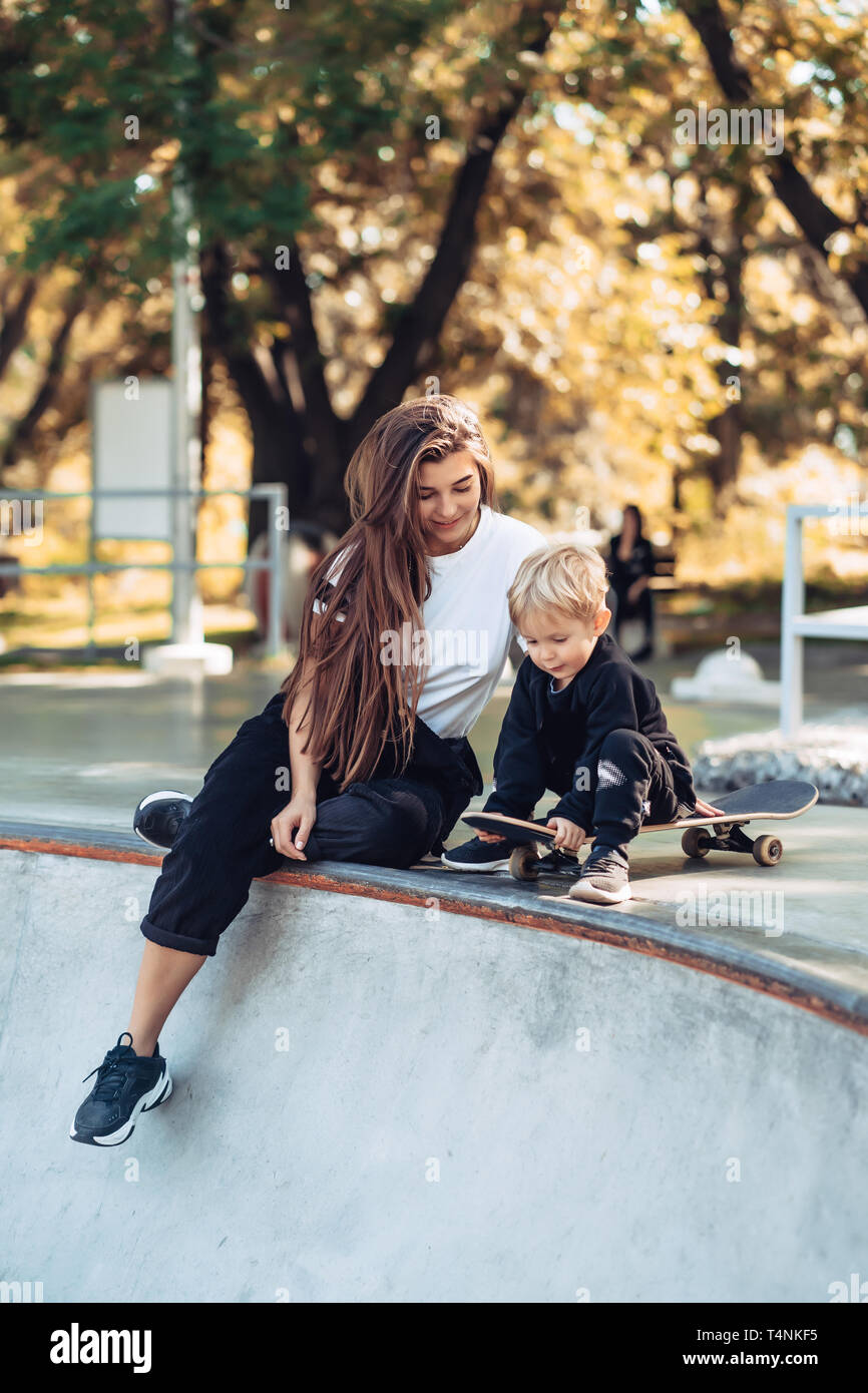 Beautiful young hipster mom and little son at the skatepark Stock Photo ...