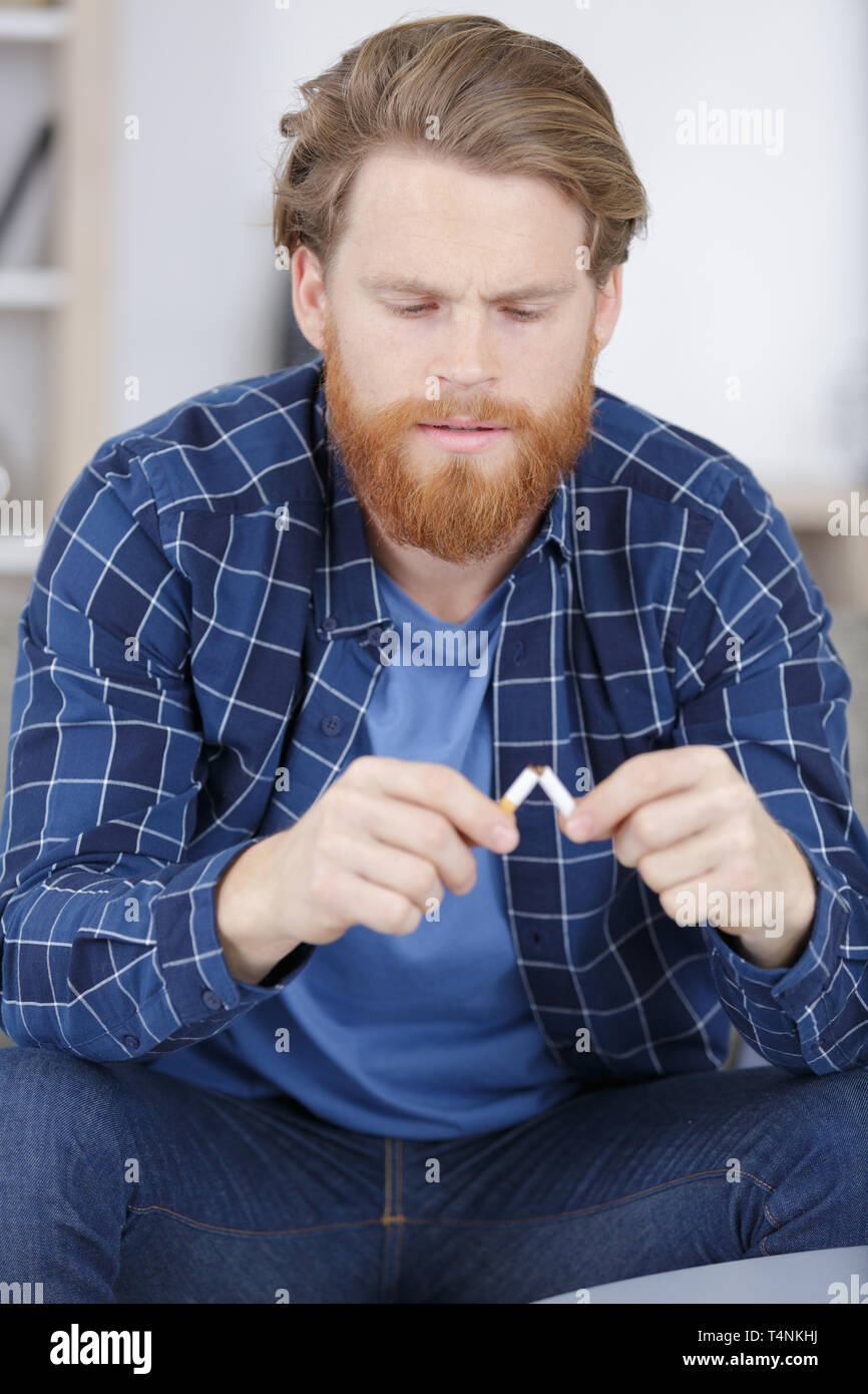 man breaking cigarette Stock Photo - Alamy