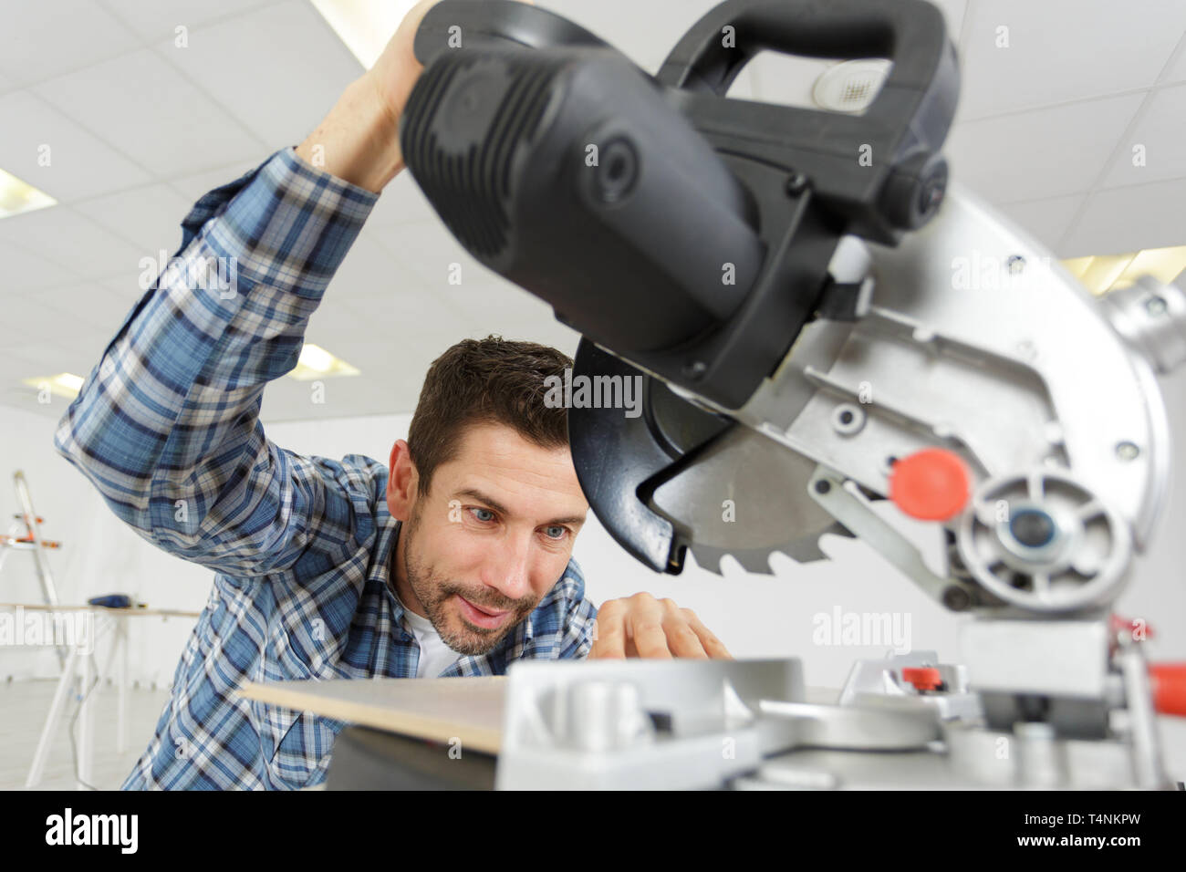 man cutting wood with circular saw Stock Photo - Alamy