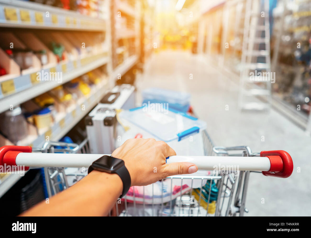 Human Hand Close Up With Shopping Cart in a Supermarket Walking Trough ...