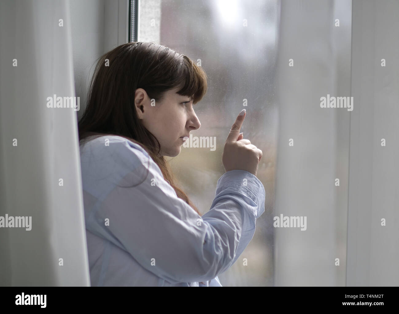 Sad face at the window hi-res stock photography and images - Alamy