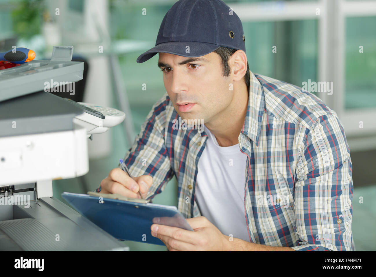 man technician repairing a printer at work Stock Photo - Alamy