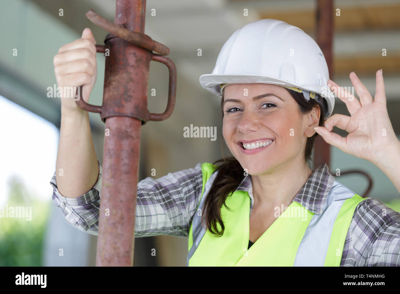 female constructor or contractor showing ok sign Stock Photo - Alamy