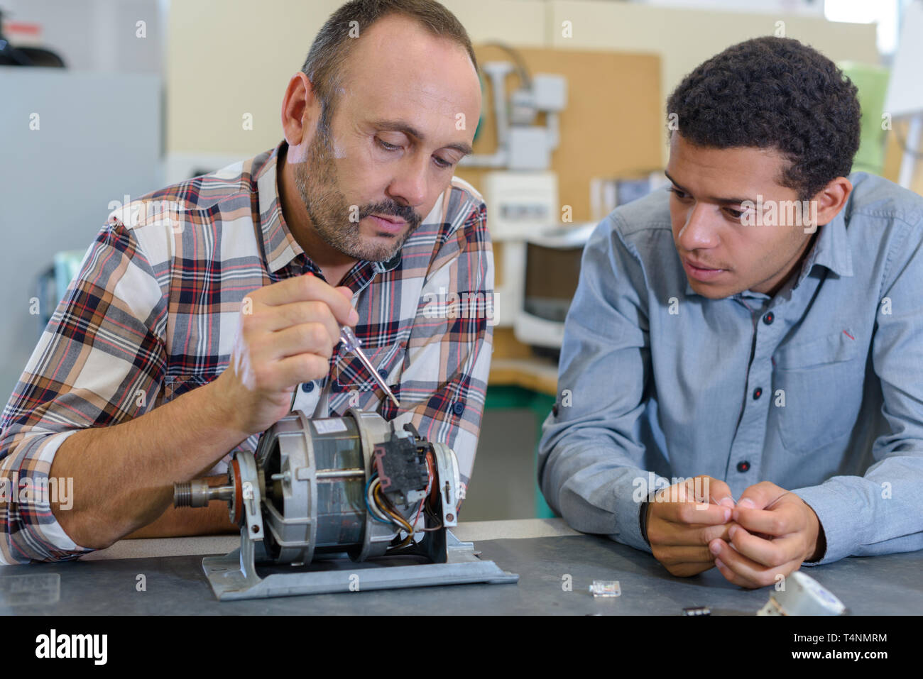 young mechanic having a mechanical part lesson Stock Photo - Alamy