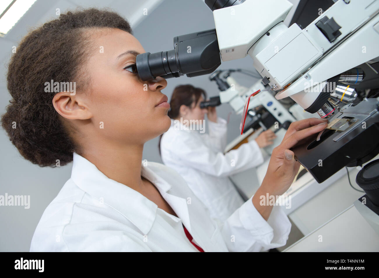 female scientist with microscope Stock Photo - Alamy
