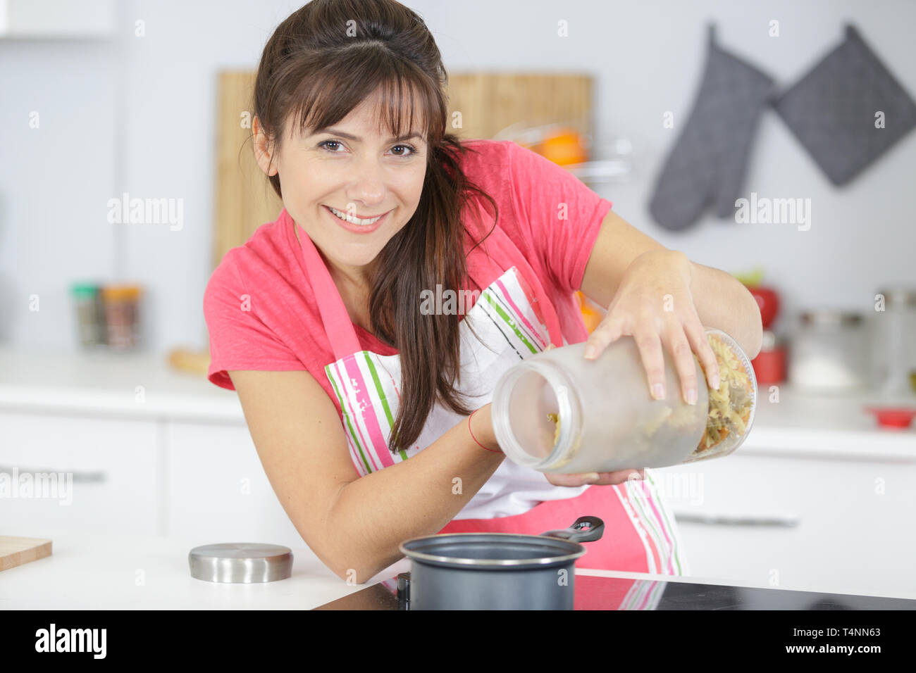 beautiful woman cooking pasta in kitchen Stock Photo - Alamy