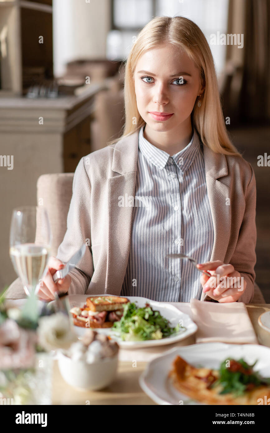 Nice woman eat breakfast in cafe. Portrait of young charming female ...