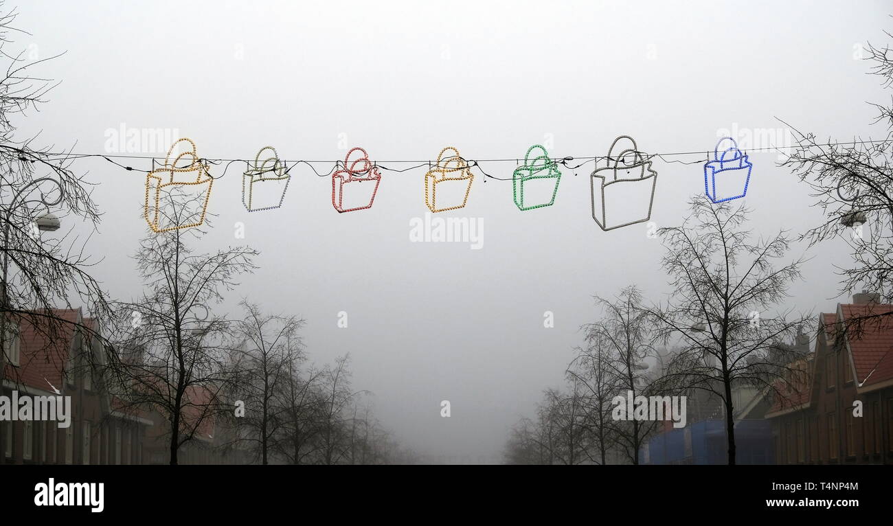 Christmas lights on a street in the mist in winter Stock Photo - Alamy