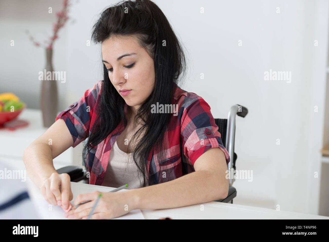 girl in wheelchair writing secret letter Stock Photo - Alamy