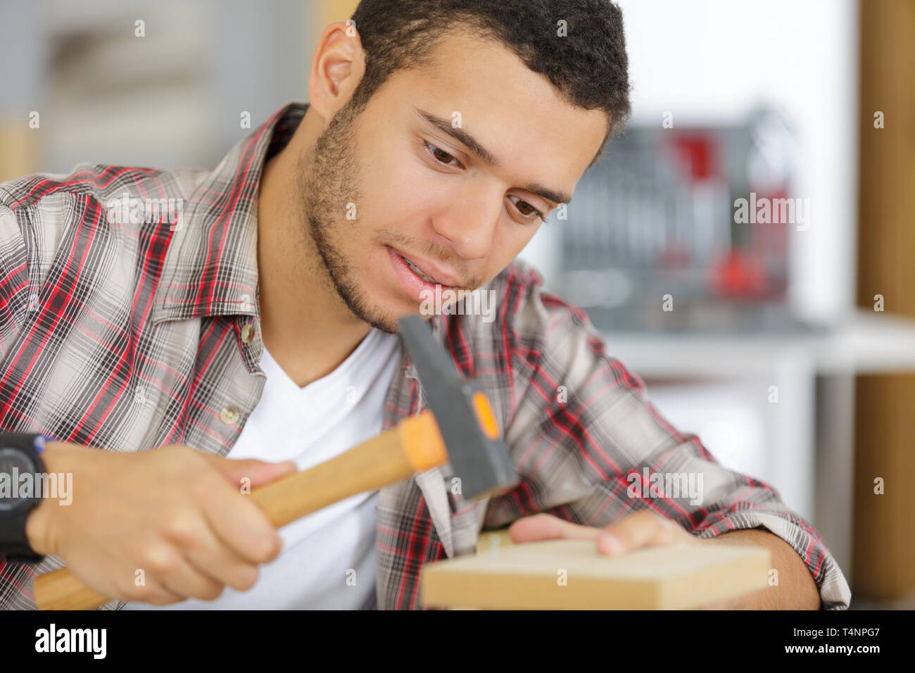 man building a house and workimg with hammer and wood Stock Photo - Alamy