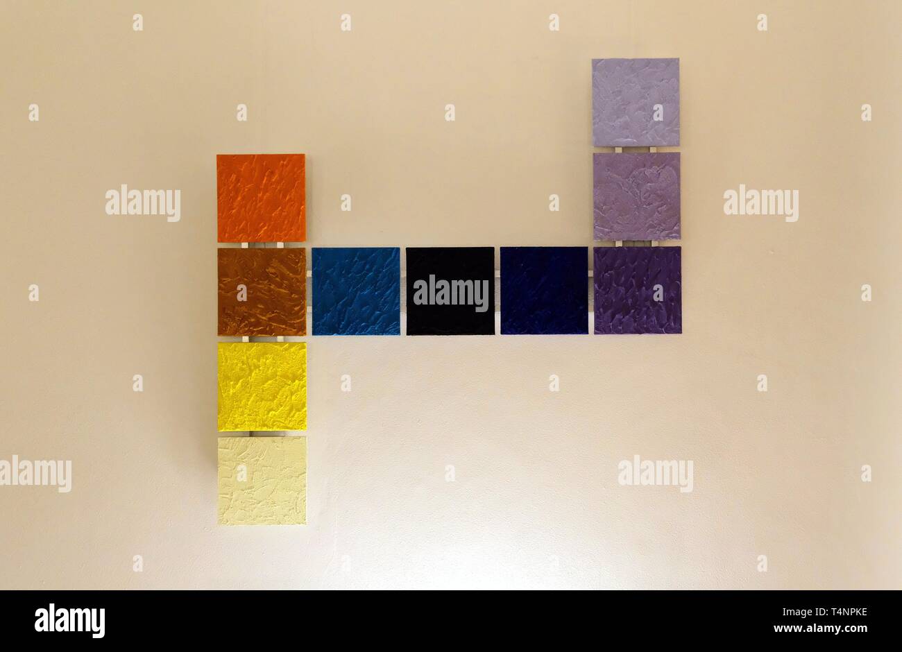 Colorful artwork of small squares on a white wall Stock Photo - Alamy
