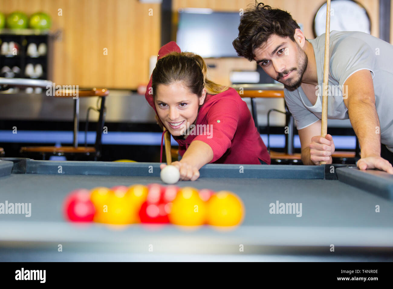 young couple playing pool in the bar Stock Photo - Alamy