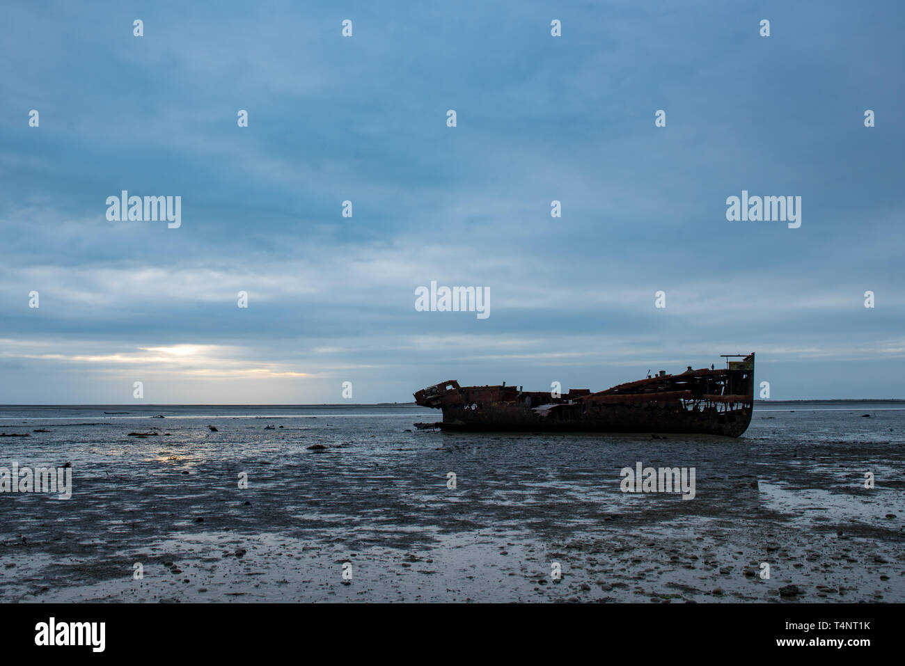 The abandoned rusty ruins of a ship wreck on Port Motueka beach Stock ...
