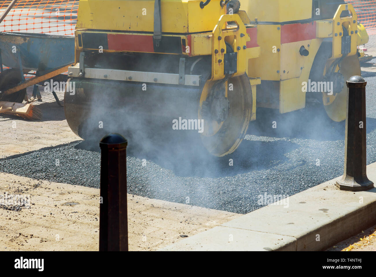 Road roller machine works on the fresh asphalt bitumen during road ...
