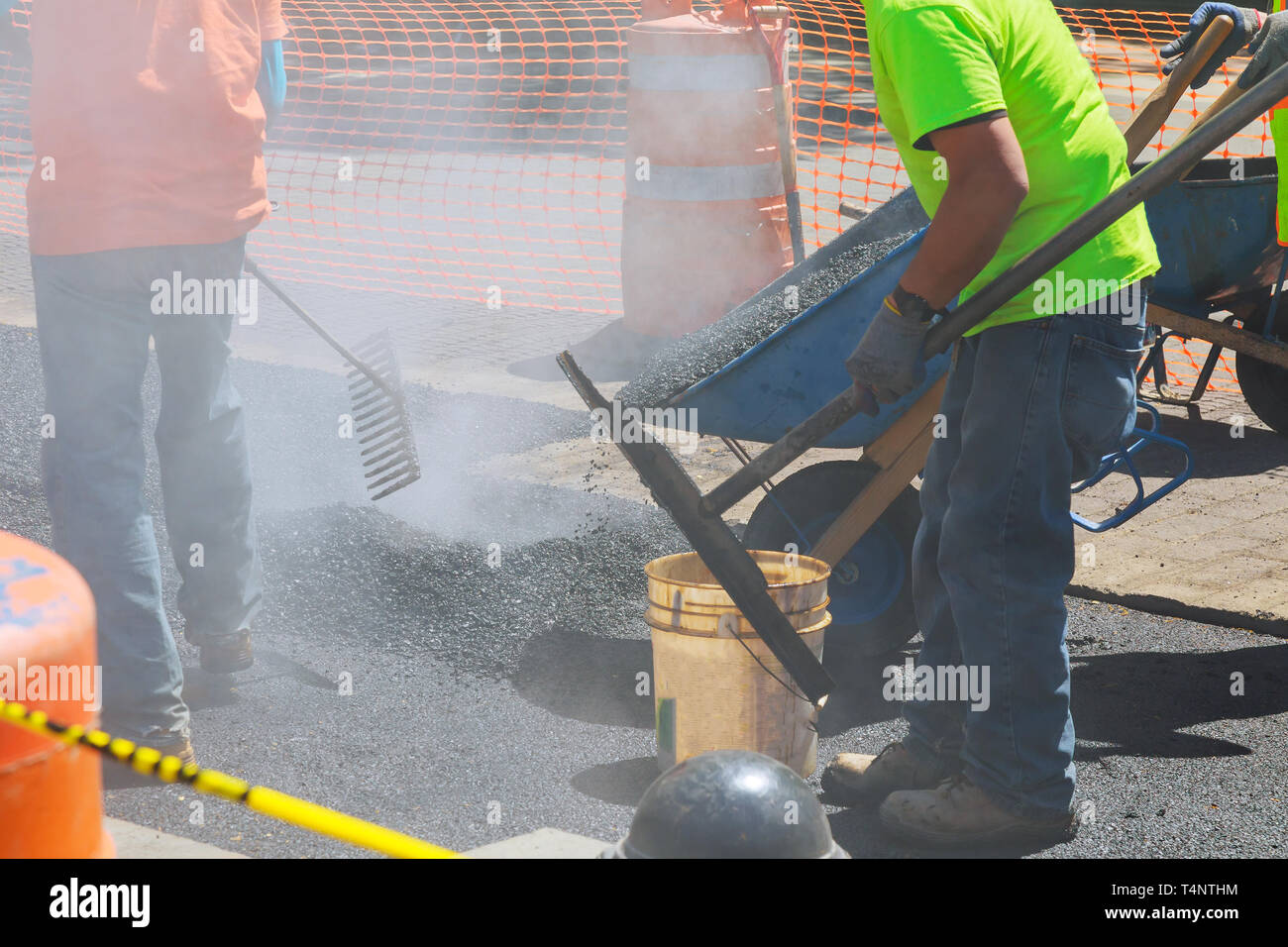 Workers on a industry aying fresh asphalt bitumen during road ...