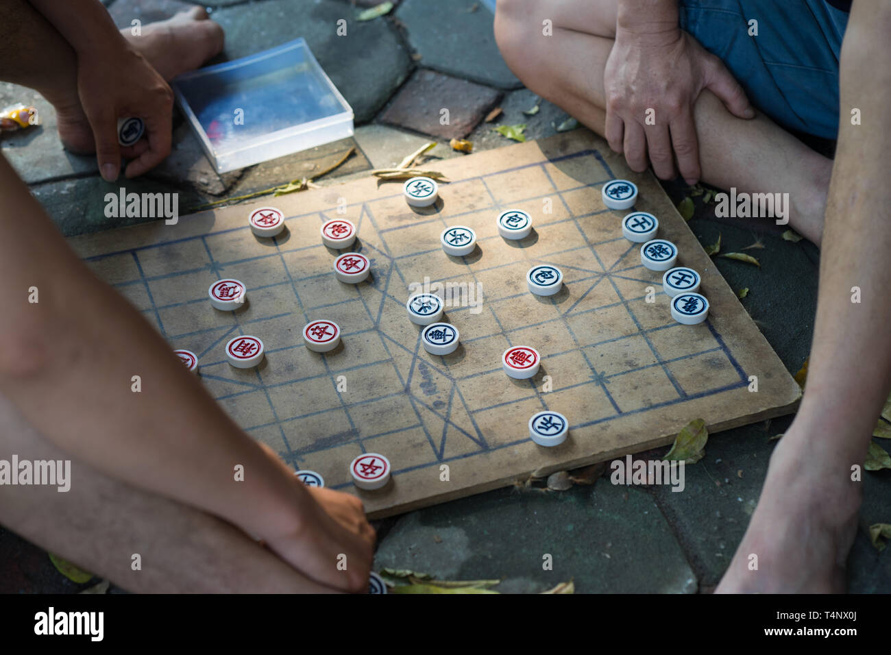 Closeup two old men playing Chinese chess on Hanoi sidewalk, Vietnam ...