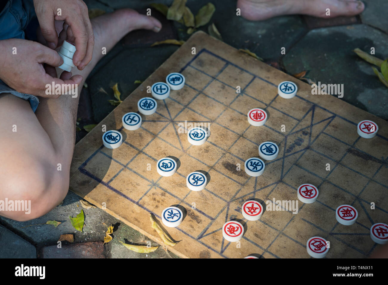 Closeup two old men playing Chinese chess on Hanoi sidewalk, Vietnam ...