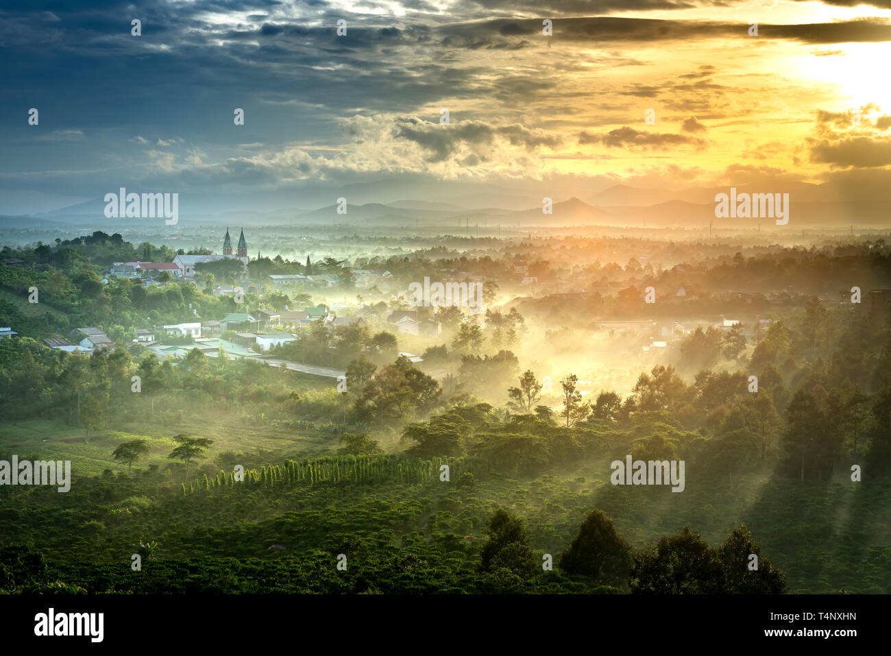 Sun rays at the valley on Bao Loc town. The far side is Thanh Xa Church ...