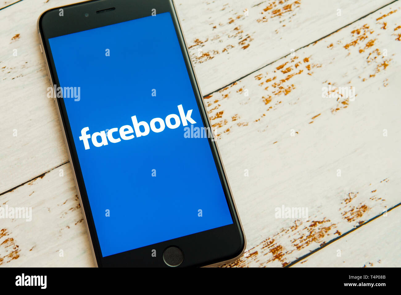 Black iPhone with logo of social media Facebook on the screen. Social ...