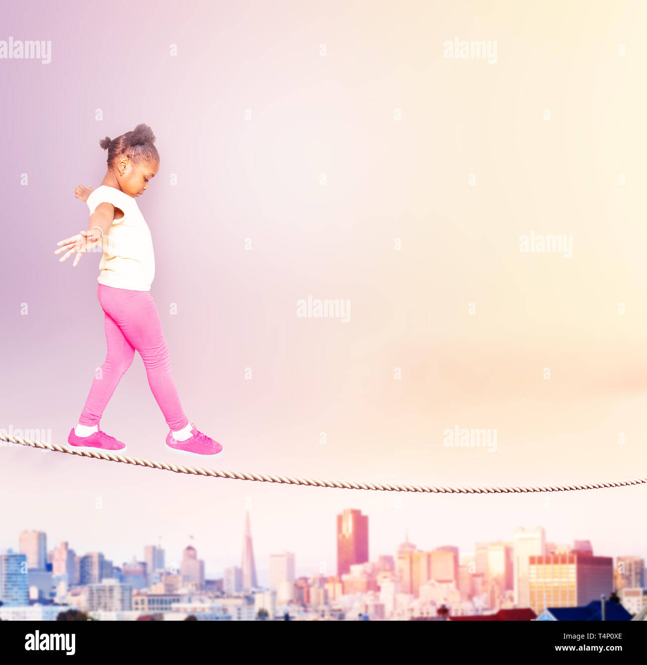 Beautiful black girl walking on the rope over city Stock Photo - Alamy