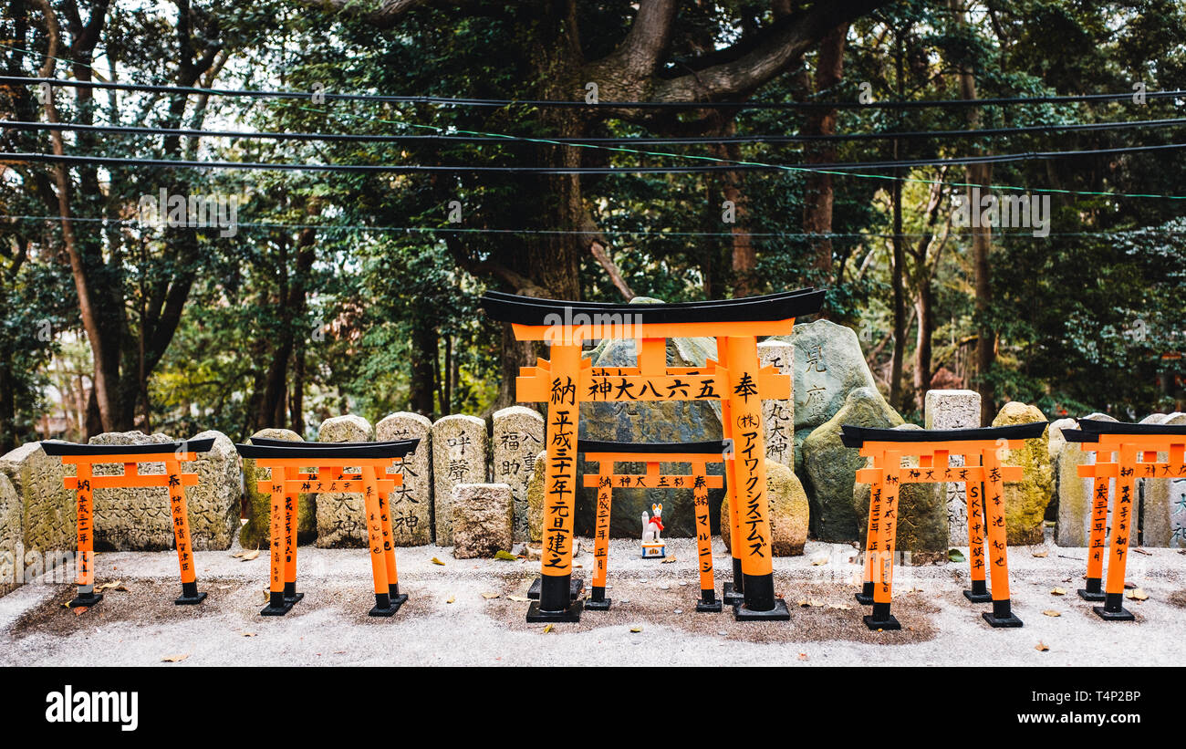 Orange gates and objects at Fushimi Inari-Taisha Shrine in Kyoto, Japan ...