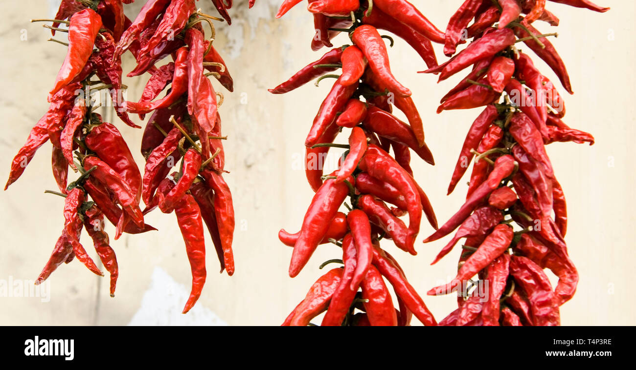Red chili hanging on the wall Stock Photo - Alamy