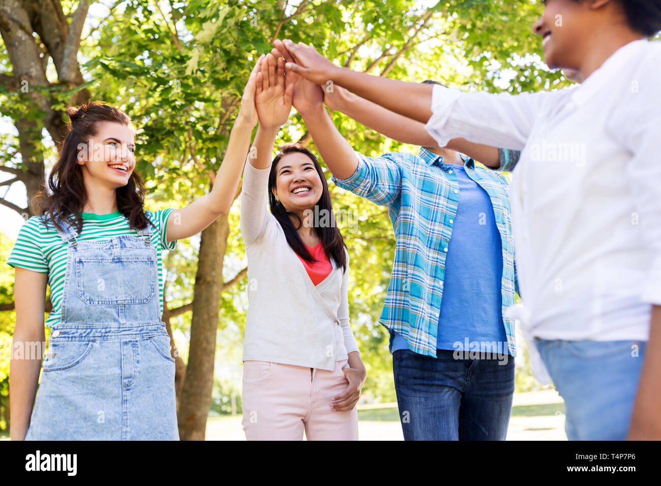 success, friendship and international concept - group of happy smiling ...