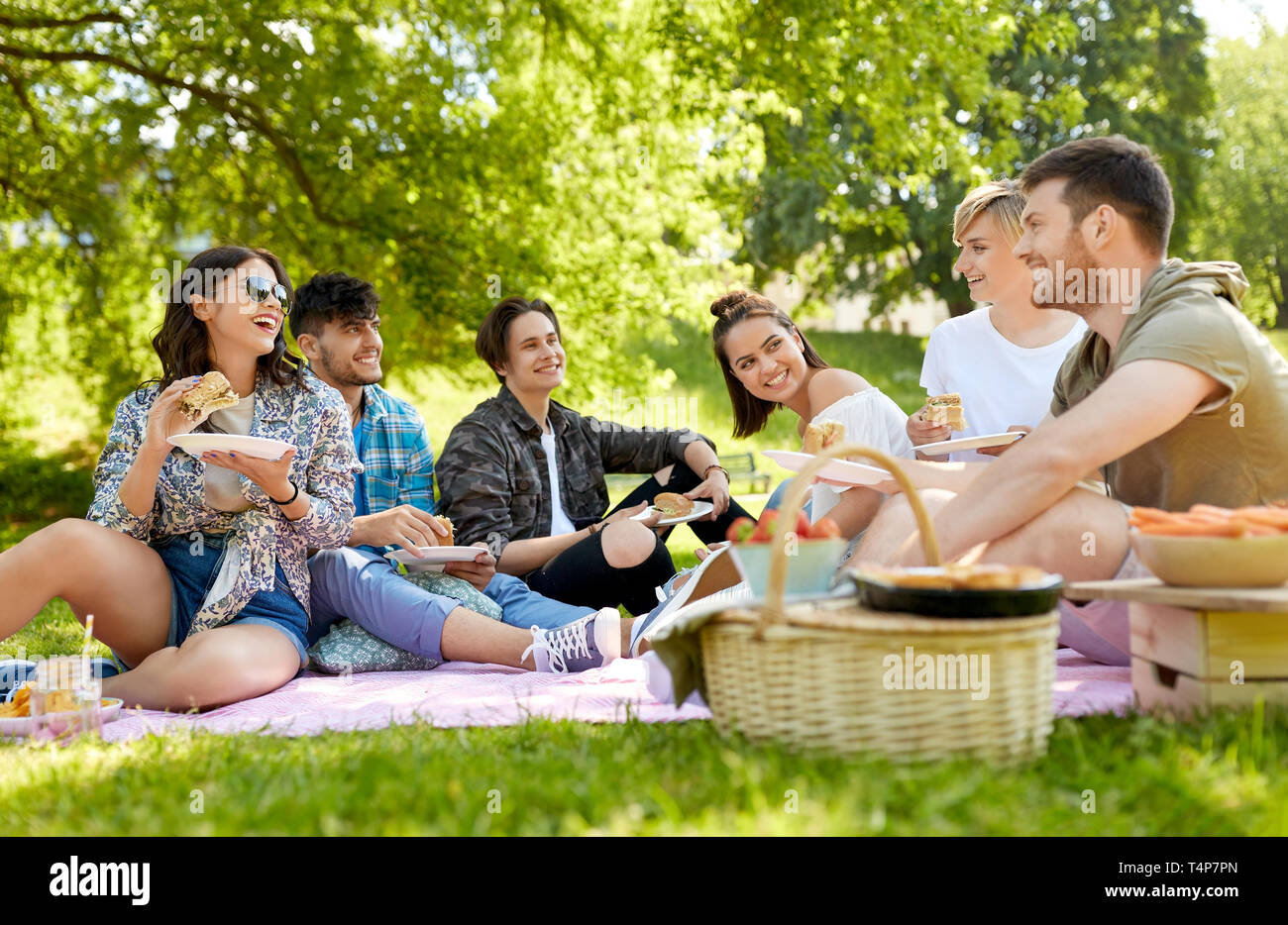 friendship, leisure and fast food concept - group of happy friends ...