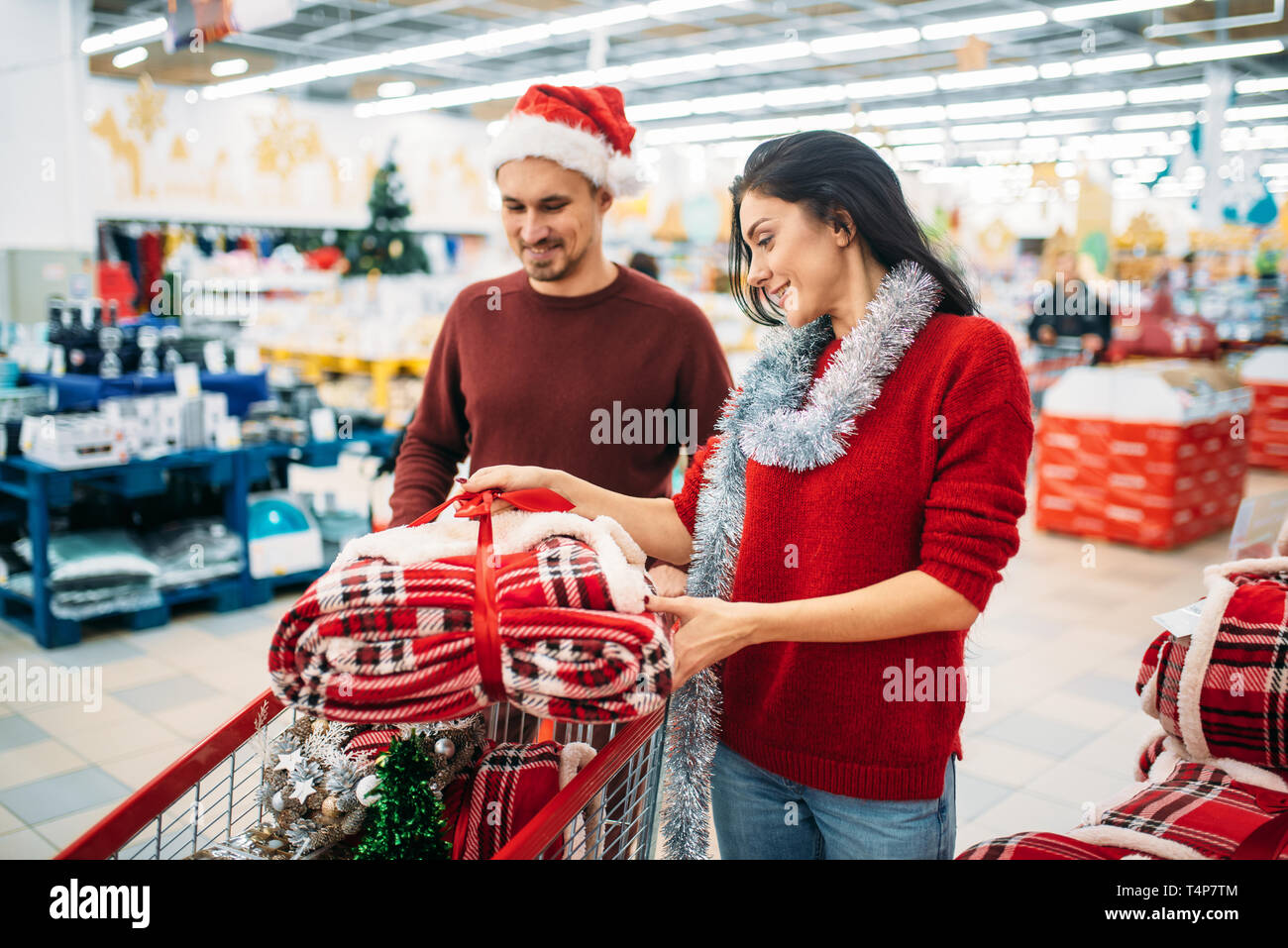 Happy couple holds boxes with Christmas toys in shop, family tradition ...